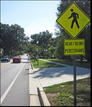 Both photos show the same crosswalk at a narrow two-lane residential ...